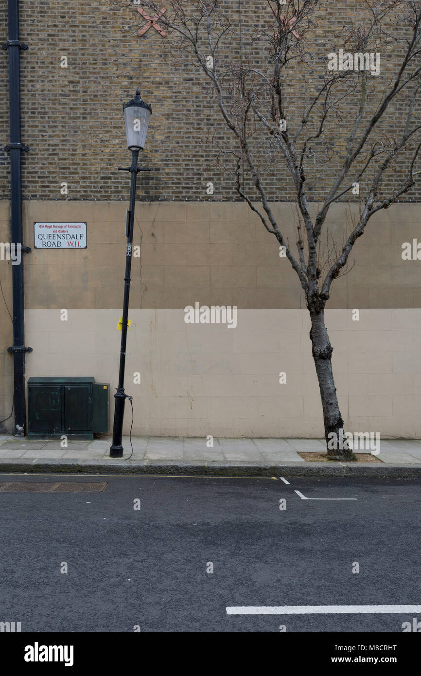 A leaning lamp post and tree on Queensdale Road W11 in Holland Park in ...