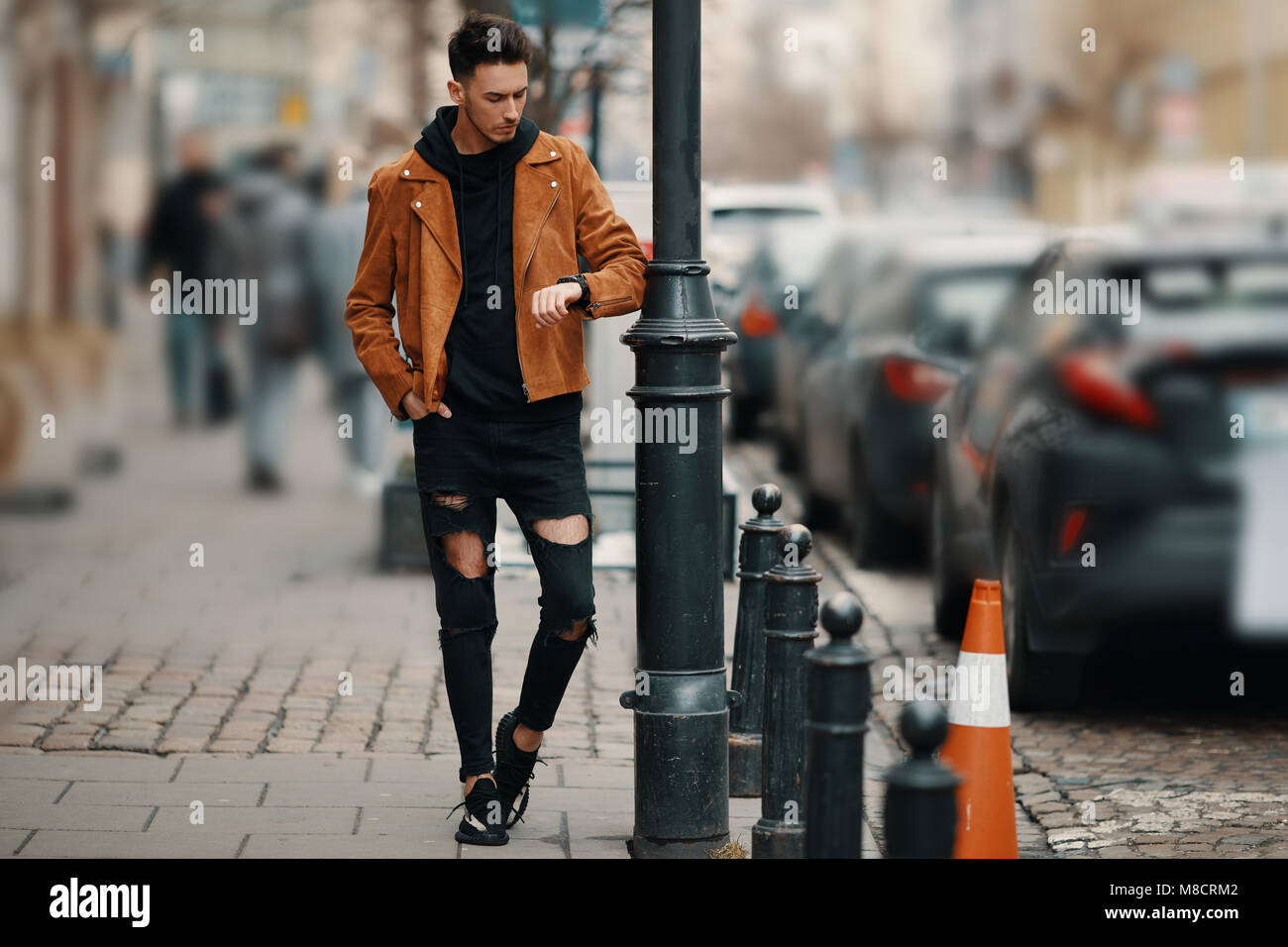 Model looking man stand near the wall and look on his watch Stock Photo ...