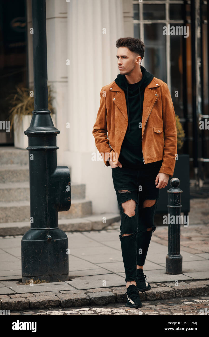 Model looking man stand on the city street with cars background, look ...