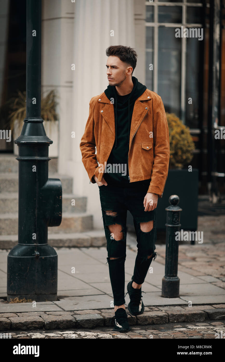 Model looking man stand on the city street with cars background, look ...