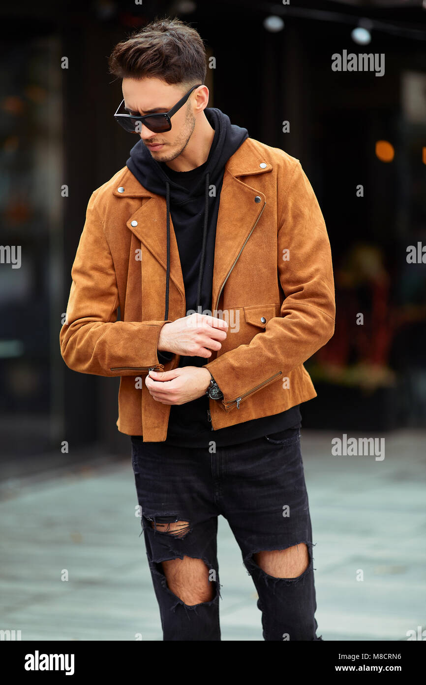 Model looking man stand on the city street with cars background, look ...