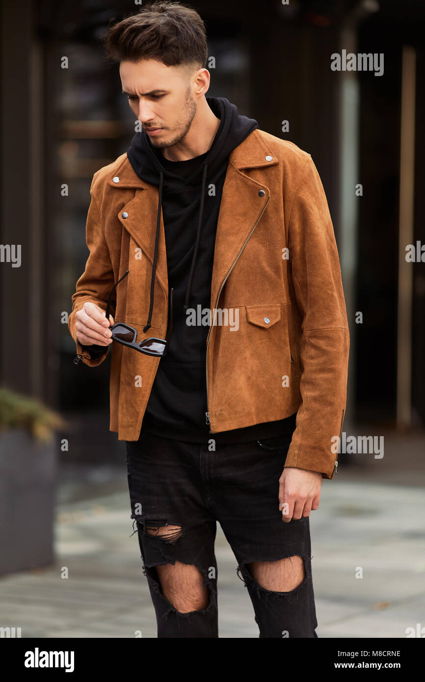 Model looking man stand on the city street with cars background, look ...