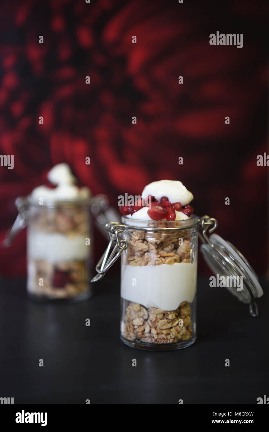 healthy food pot with granola cereal and yoghurt on black Stock Photo ...