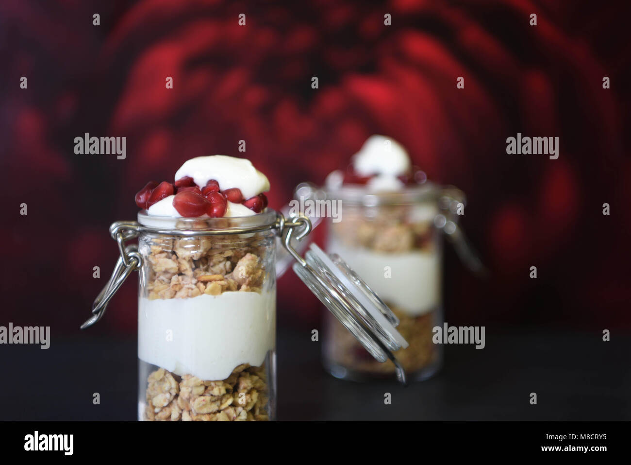 healthy food pot with granola cereal and yoghurt on black Stock Photo ...