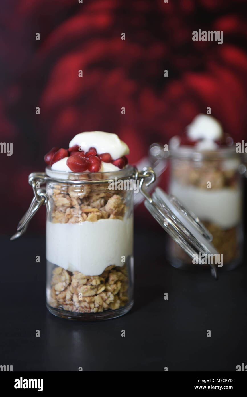 healthy food pot with granola cereal and yoghurt on black Stock Photo ...