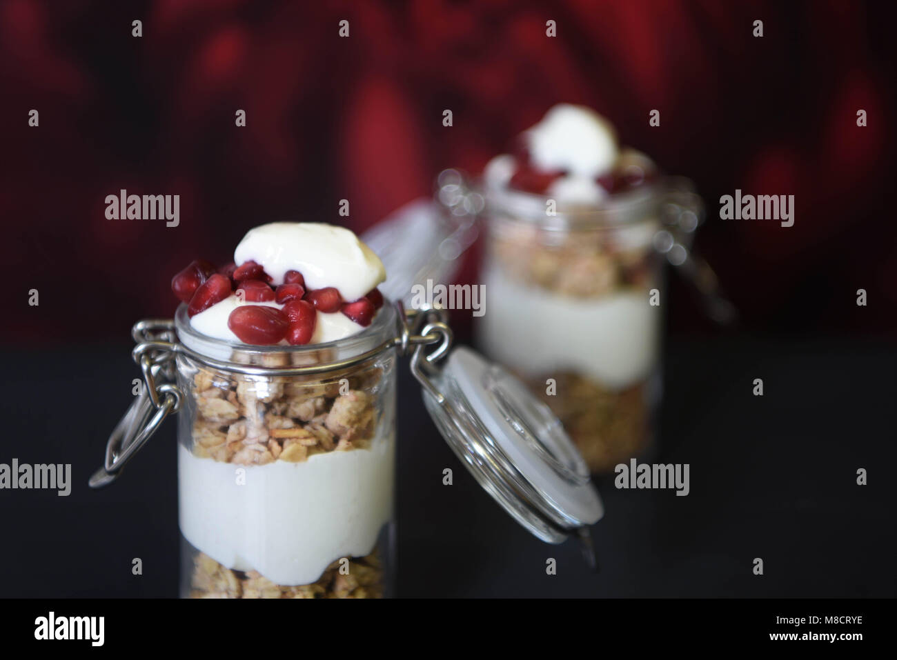 healthy food pot with granola cereal and yoghurt on black Stock Photo ...