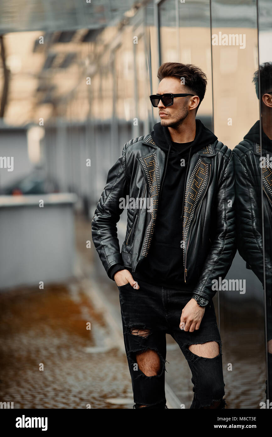 Model looking man stand on the city street with cars background, look ...