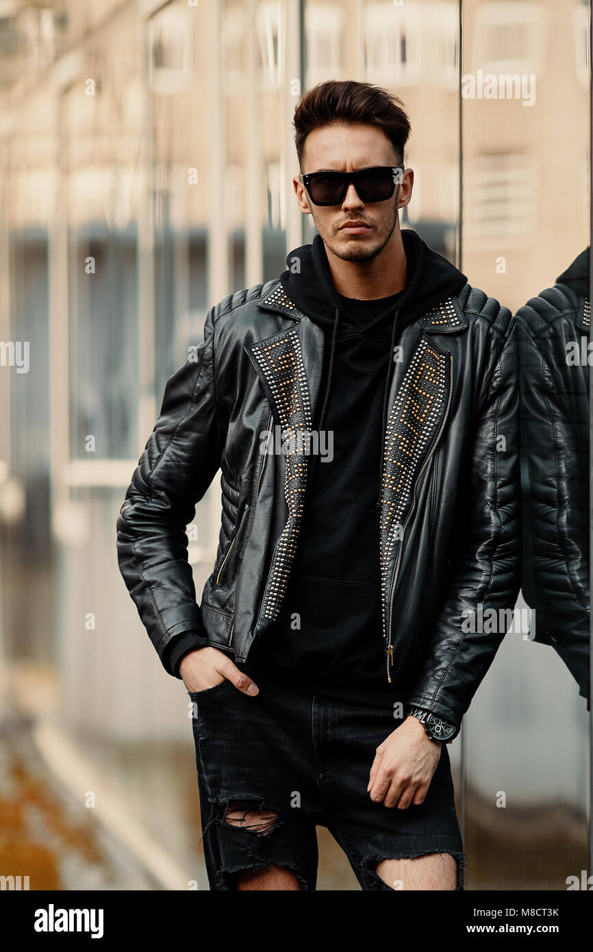 Model looking man stand on the city street with cars background, look ...