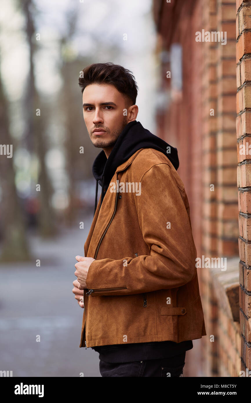 Model looking man stand near the wall and look on his watch Stock Photo ...