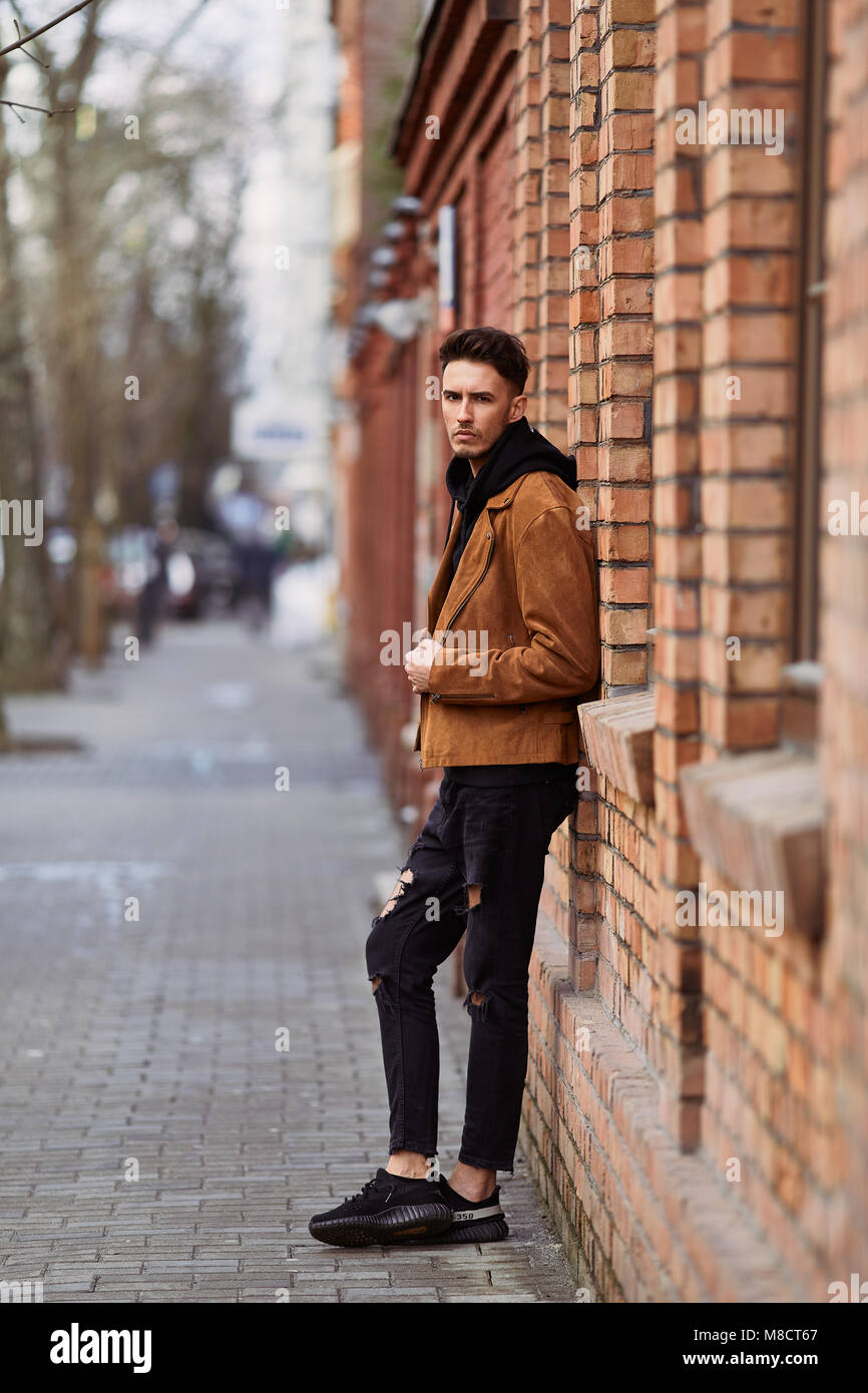 Model looking man stand near the wall and look on his watch Stock Photo ...
