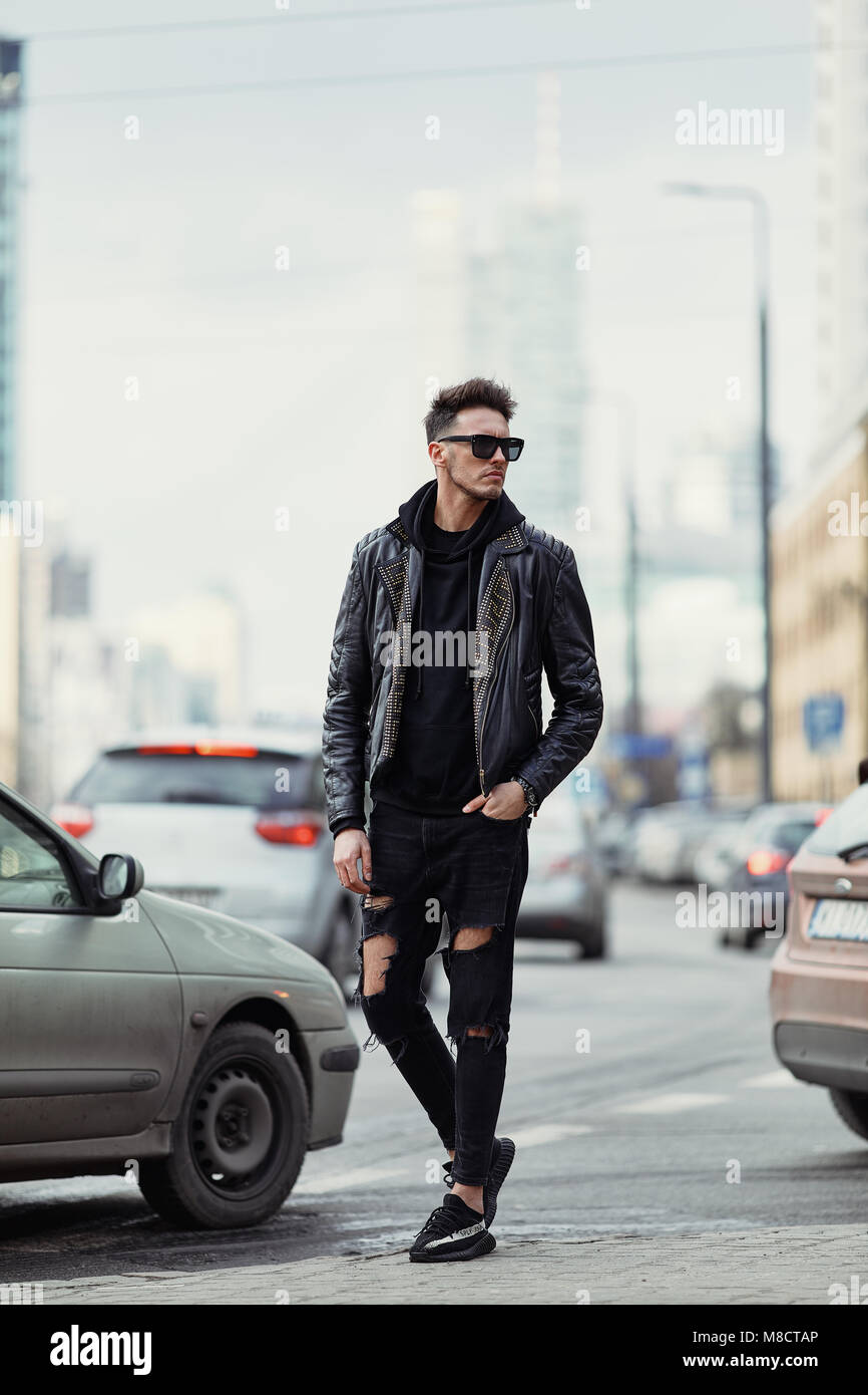 Model looking man stand on the city street with cars background, look ...