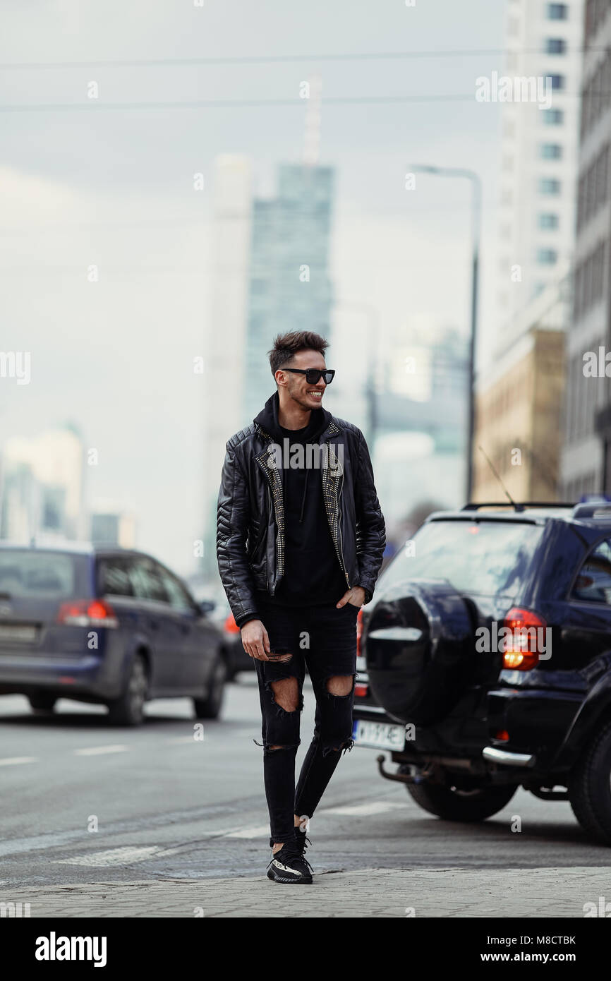 Model looking man stand on the city street with cars background, look ...