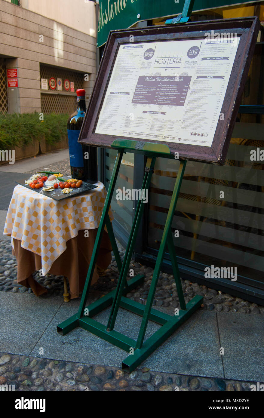 Menu with table set outside Italian restaurant - Milan Stock Photo - Alamy