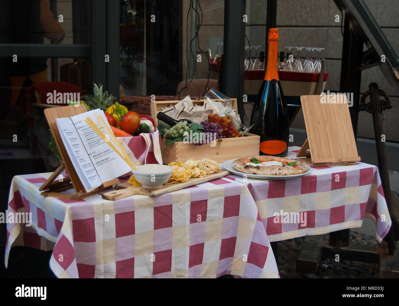 Menu with table set outside Italian restaurant - Milan Stock Photo - Alamy