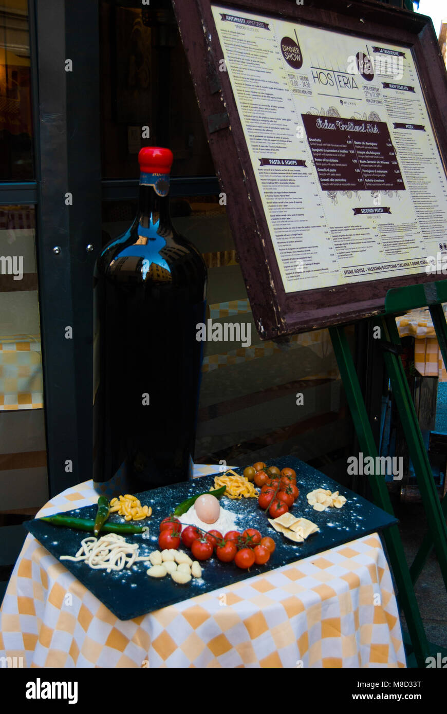 Menu with table set outside Italian restaurant - Milan Stock Photo - Alamy