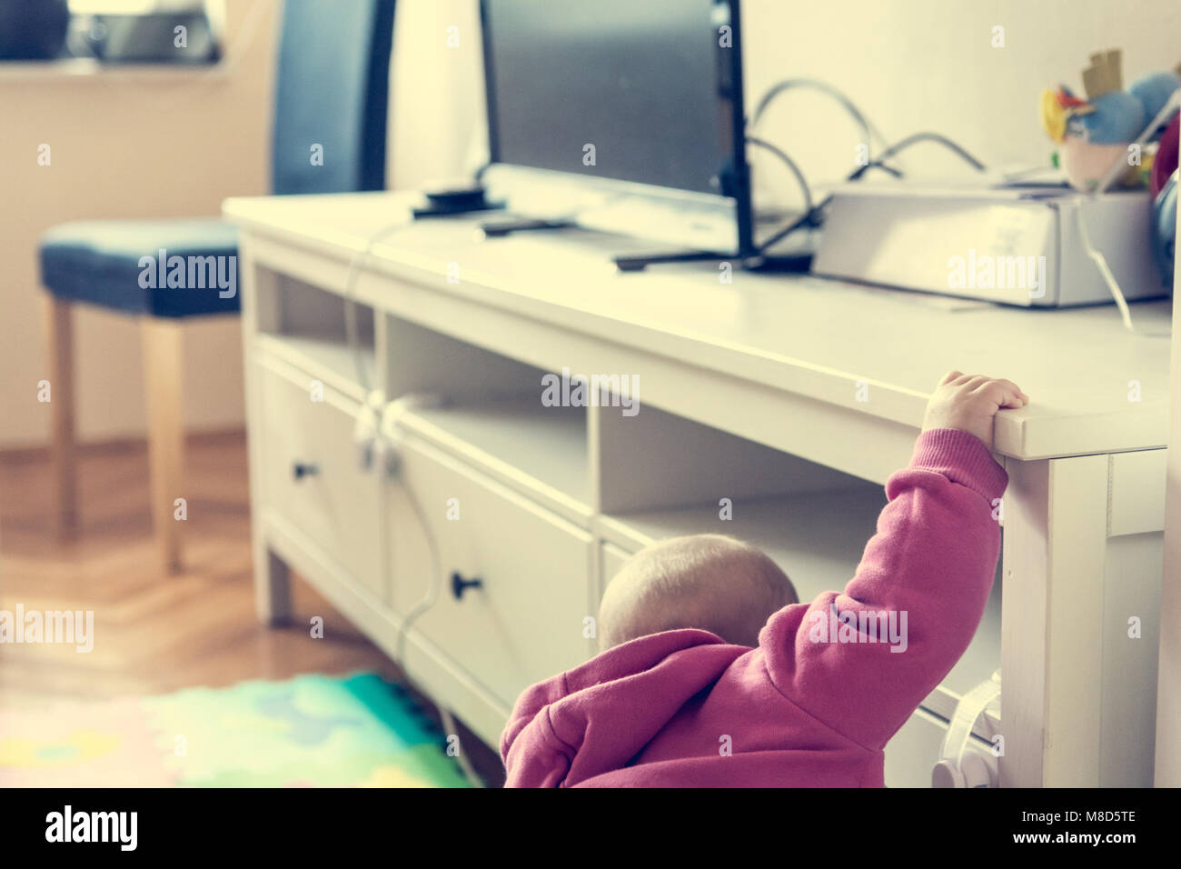 Baby exploring living room Stock Photo - Alamy