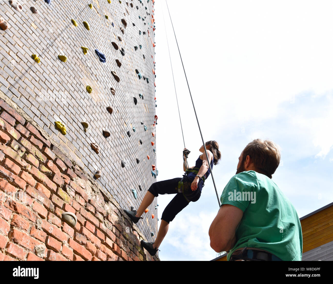 people bouldering in a climbing hall - indoor sports Stock Photo - Alamy