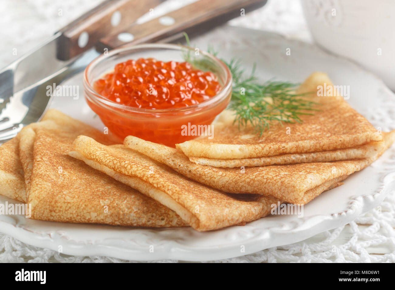 Traditional Russian pancakes (blini ) with salmon caviar on a white ...