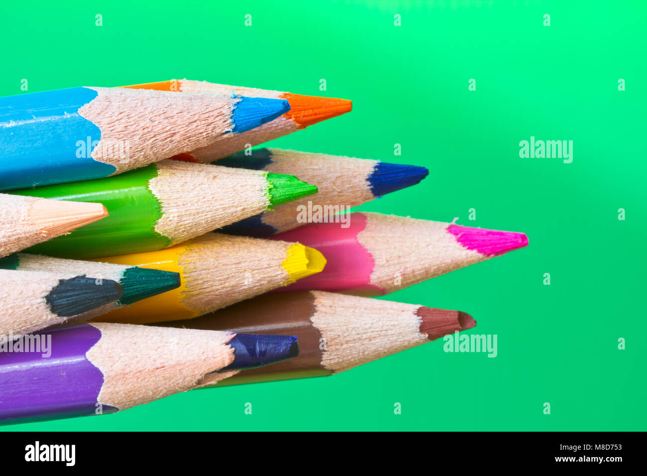 color pencils on green background Stock Photo - Alamy