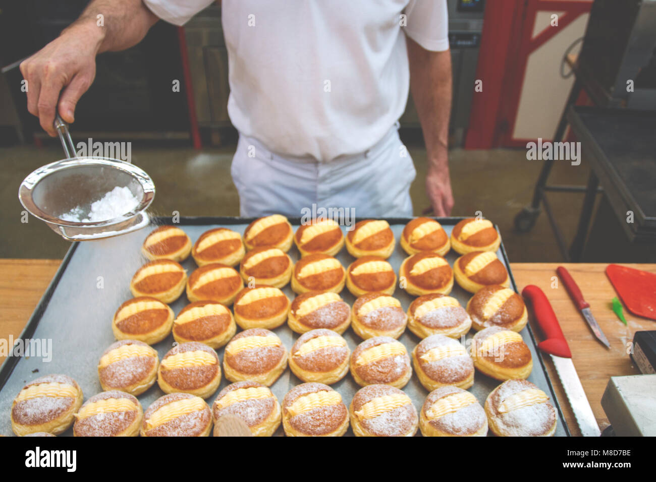 sprinkle the pastry with powdered sugar through a sieve Stock Photo - Alamy