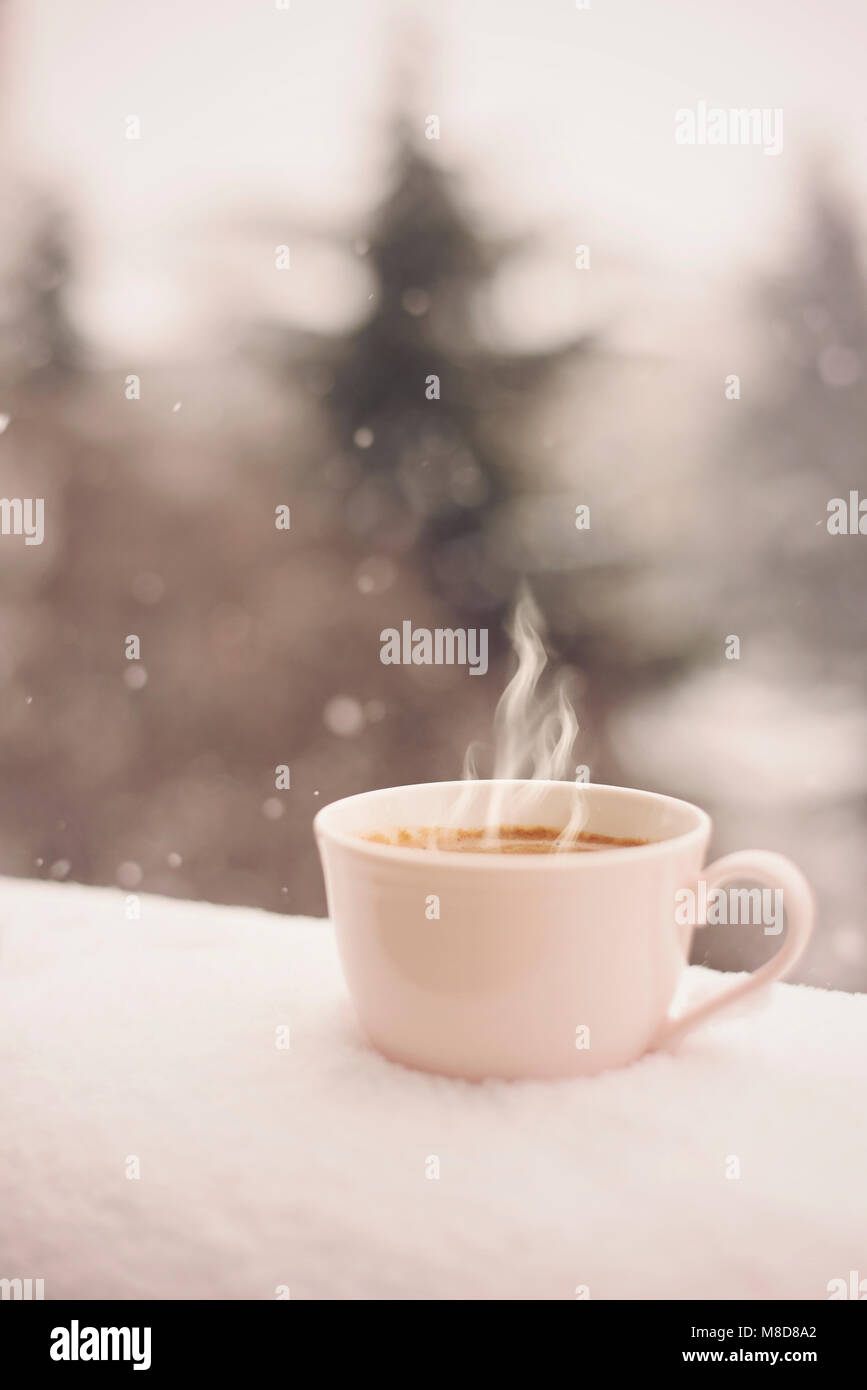 A coffee in the snow. Pink coffee cup, coffee mug. Beautiful winter ...