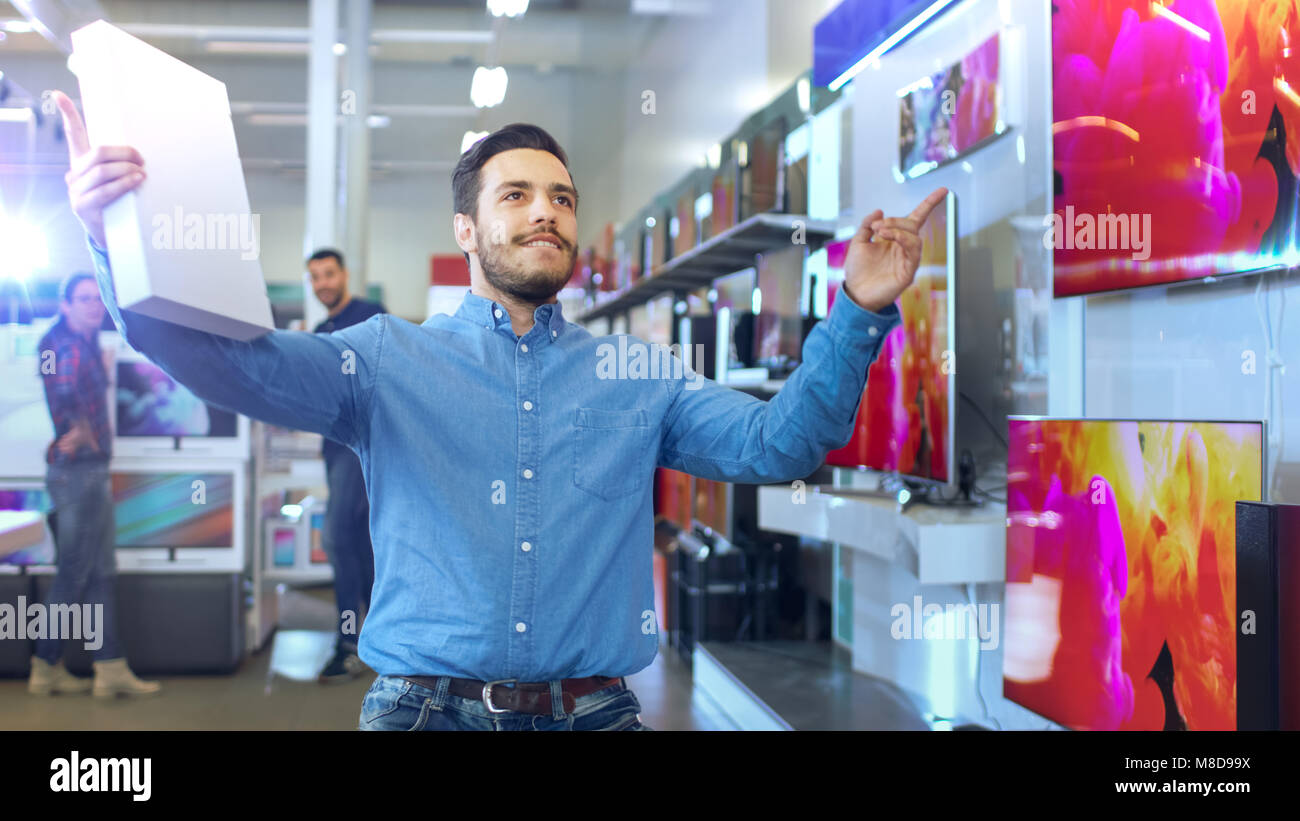 Young Man in Electronics Store Purchased Latest Model of the Tablet ...