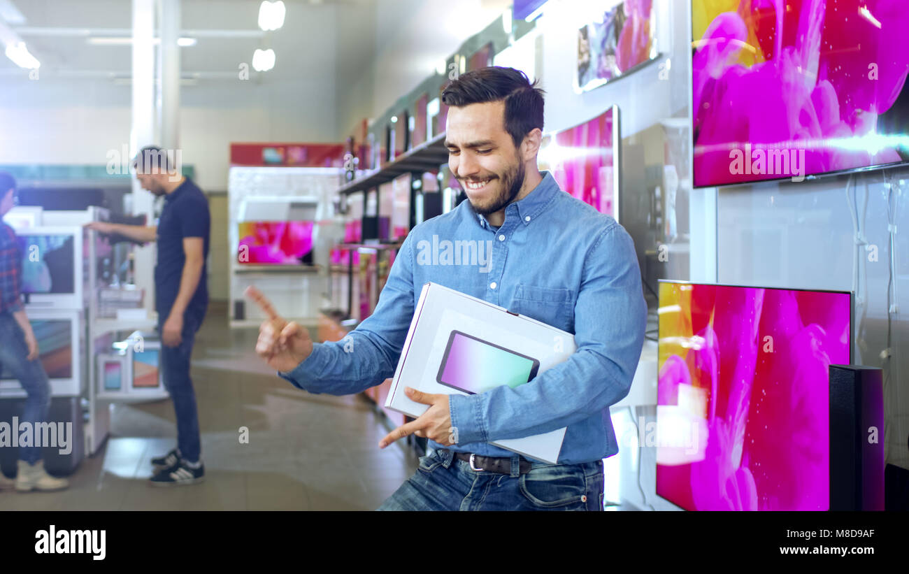 Young Man in Electronics Store Purchased Latest Model of the Tablet ...