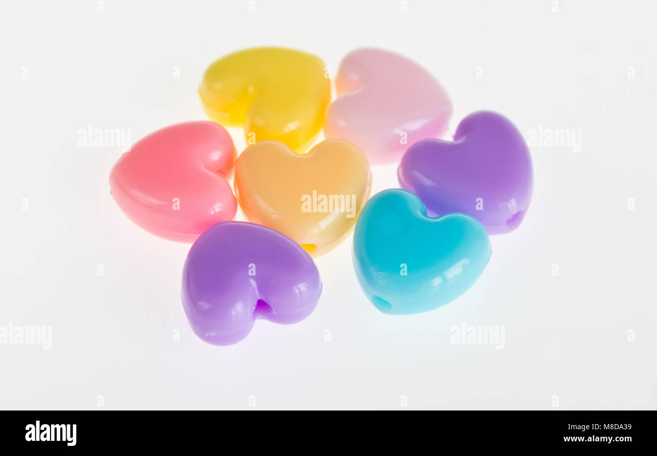 Heart shaped plastic beads arranged in concept (isolated on white Stock ...