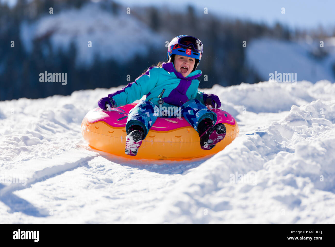 Sledding fun in winter-wonderland Stock Photo - Alamy
