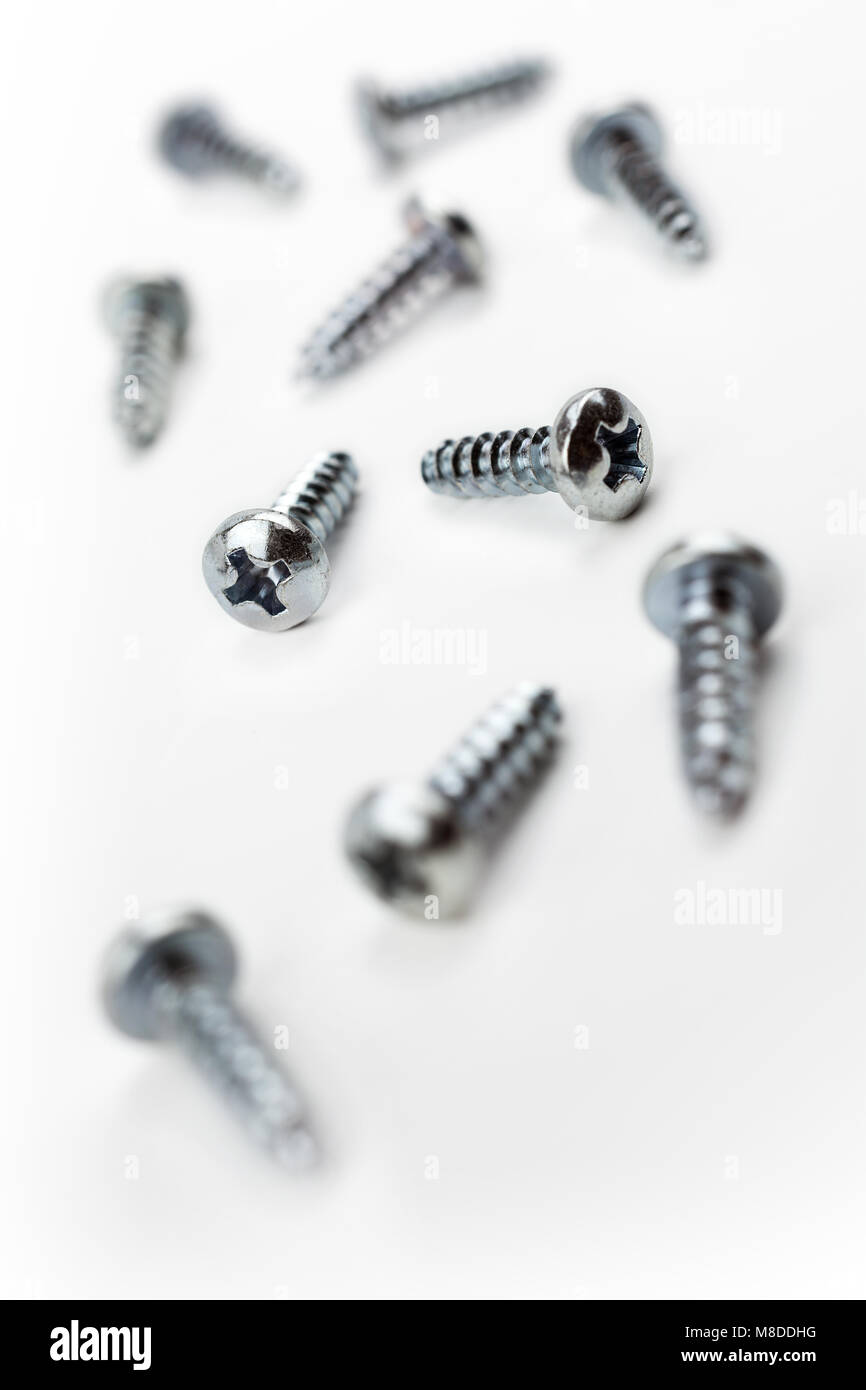 Small Iron Screws In A White Box - Crooked Angle Stock Photo - Alamy