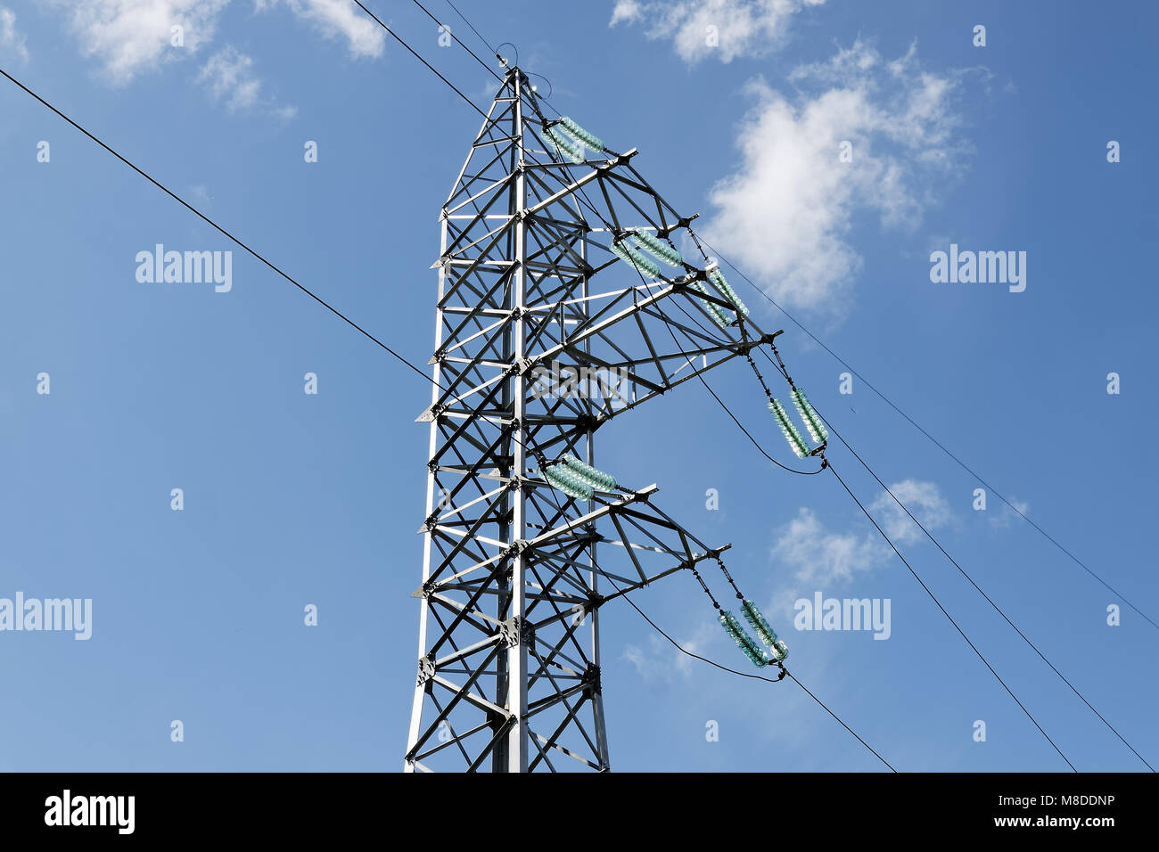 Electric pylon against the backdrop of the blue sky on a summer day ...
