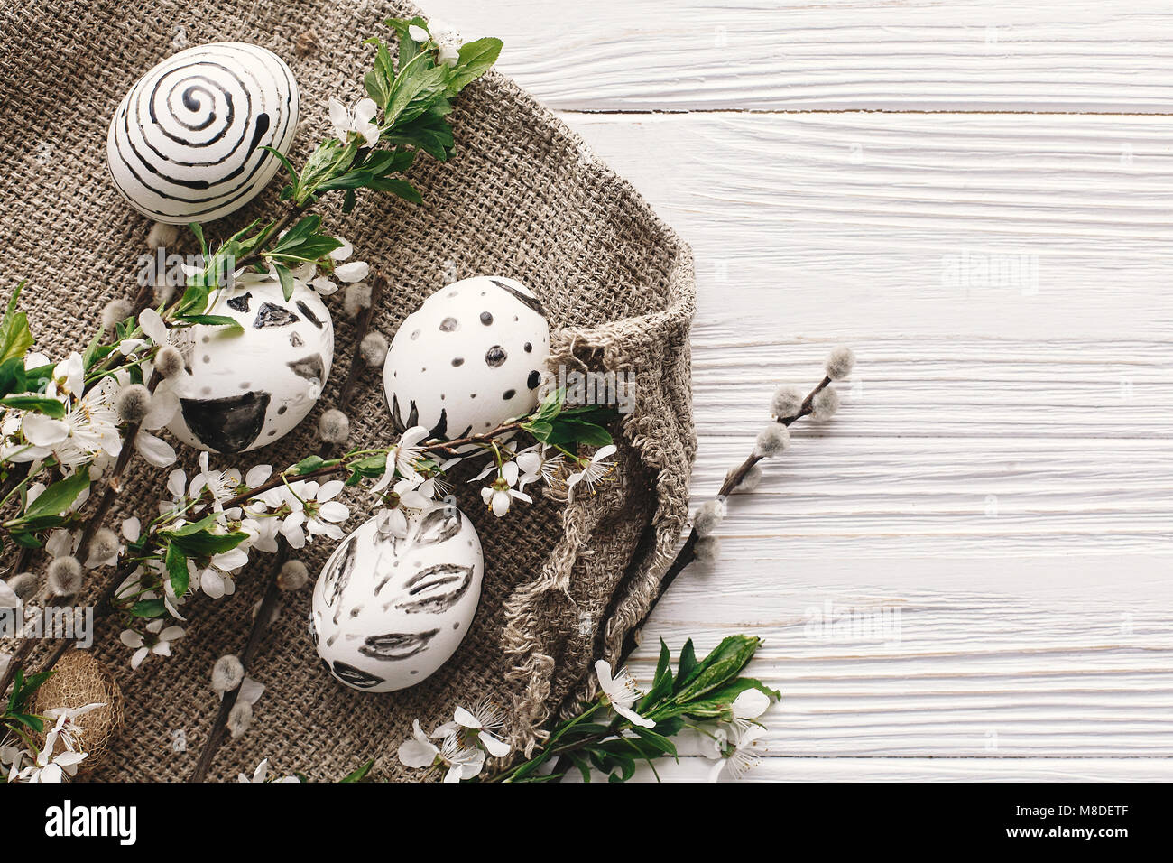 stylish painted easter eggs black and white colors at rustic wooden ...