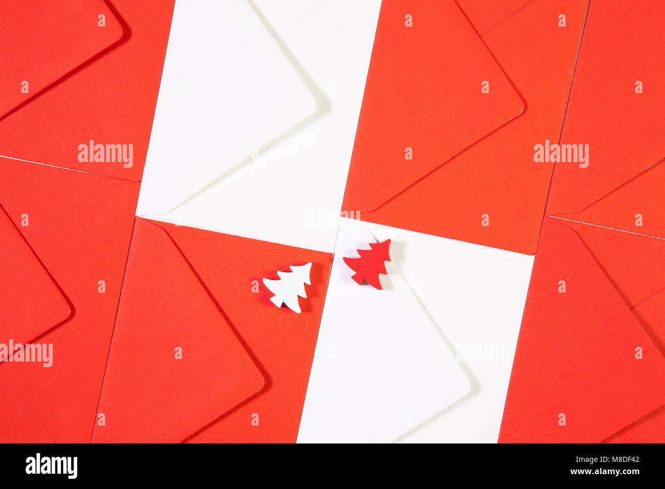 Pattern from red and white envelopes with red and white wooden trees ...