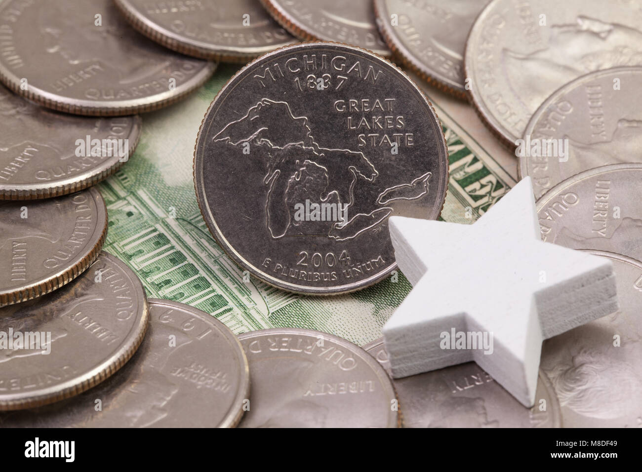 A quarter of Michigan, quarters of USA and white star. A circle of the ...