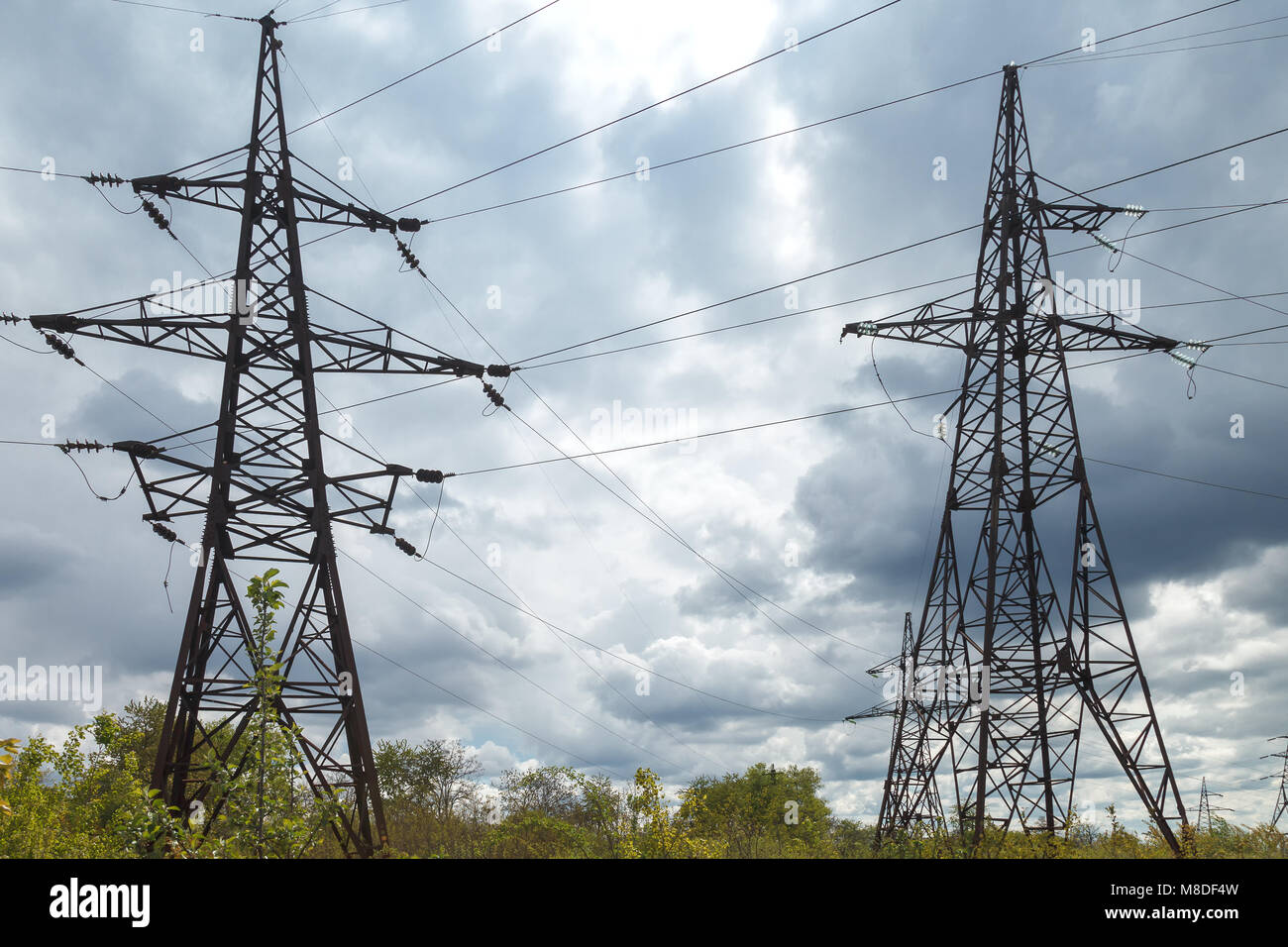 High-voltage transmission lines, metal supports, concrete poles Stock ...