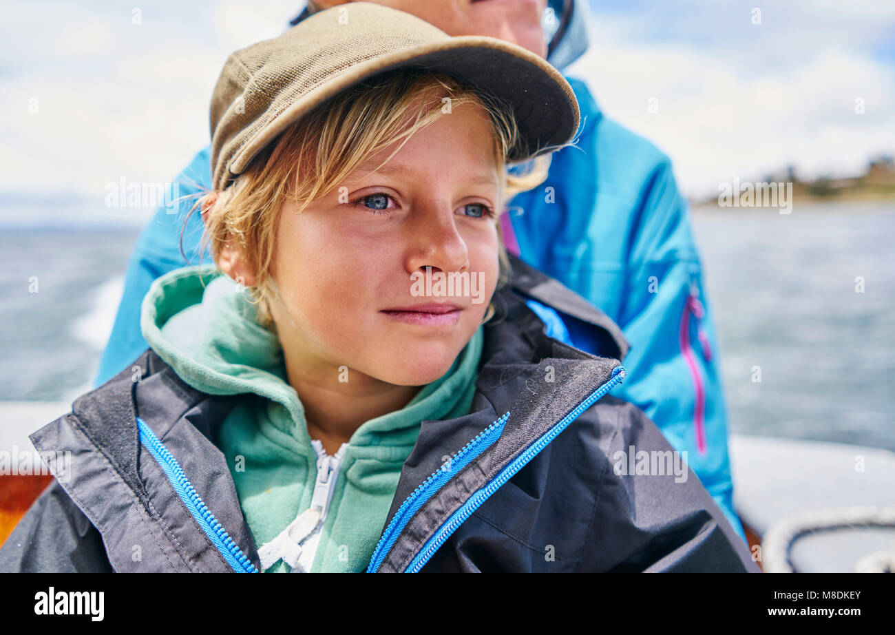 Boy and his mother on motor boat at sea, Puno, Peru Stock Photo - Alamy