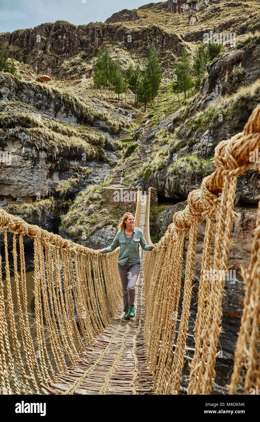 Mature woman crossing Inca rope bridge, Huinchiri, Cusco, Peru Stock ...