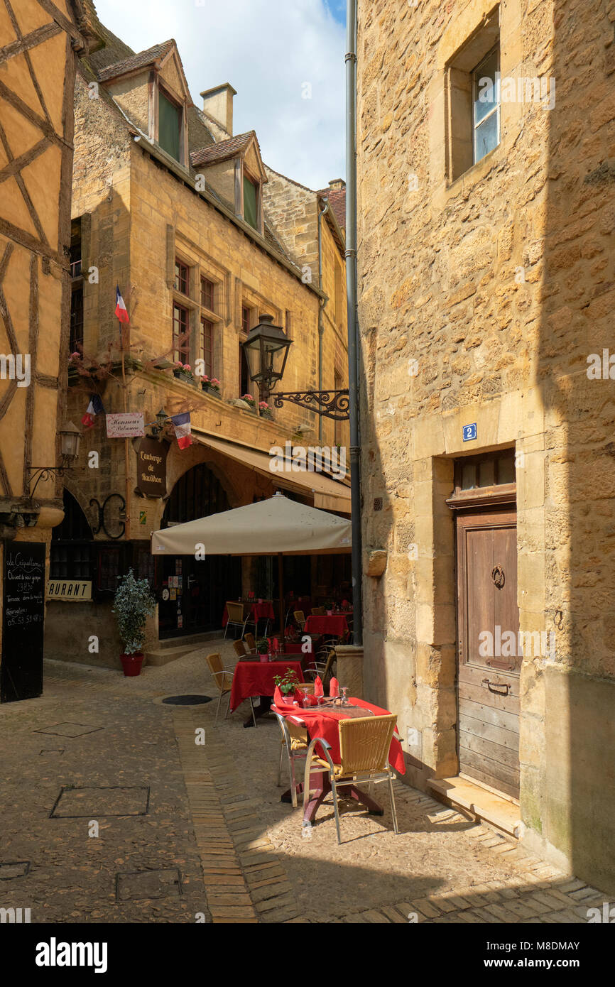 An outside table for two in the medieval town of Sarlat la Caneda in ...