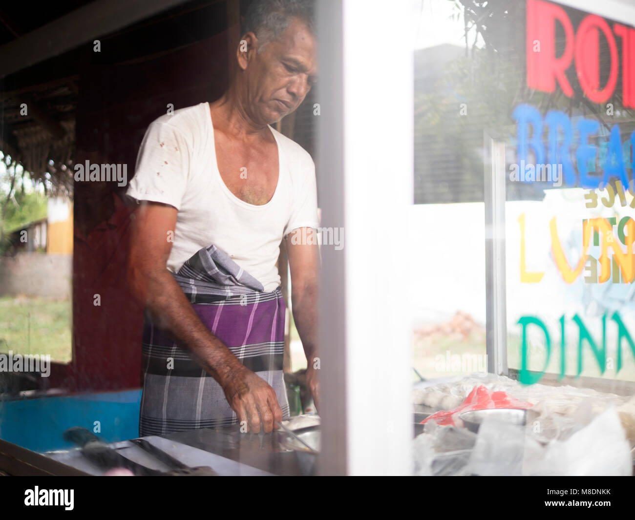 Man working in roti stall Stock Photo - Alamy