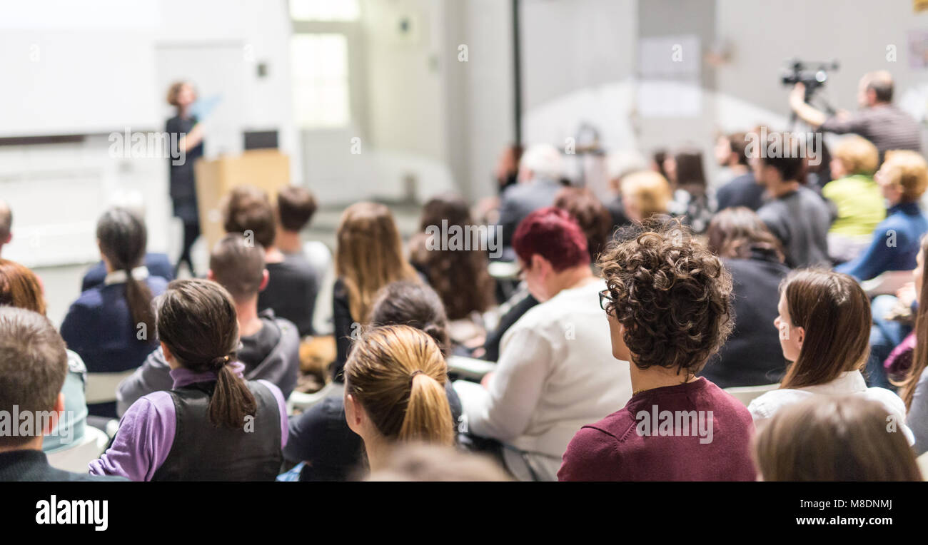 Woman giving presentation in lecture hall at university Stock Photo - Alamy