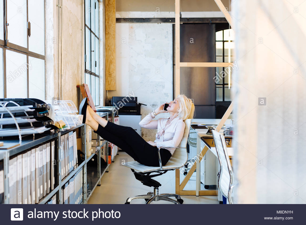 Woman Legs Up Chair Stock Photos & Woman Legs Up Chair Stock Images - Alamy