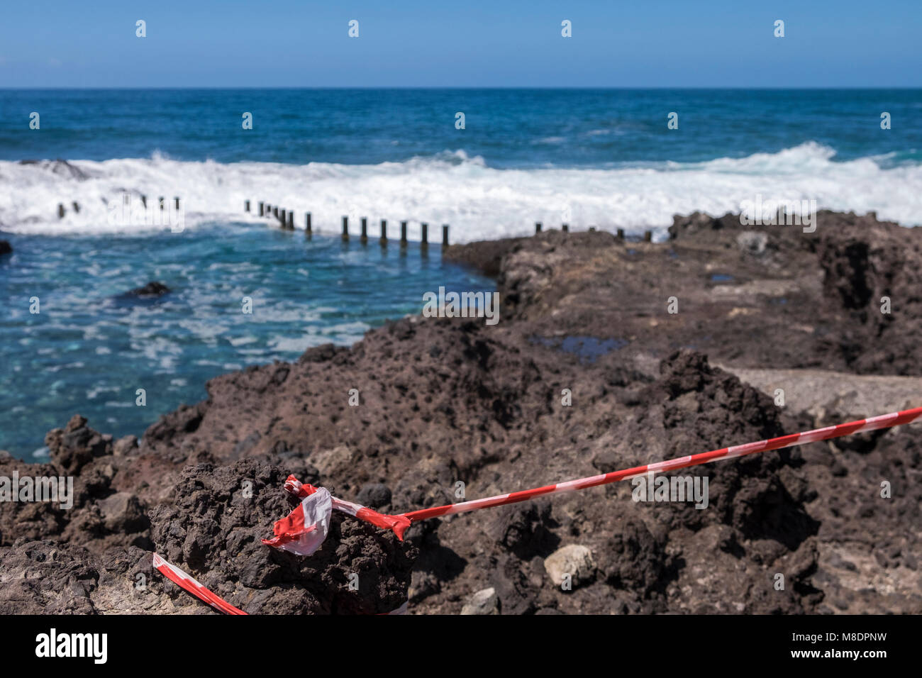 Red tape across the rocks to prevent people going to the shoreline ...