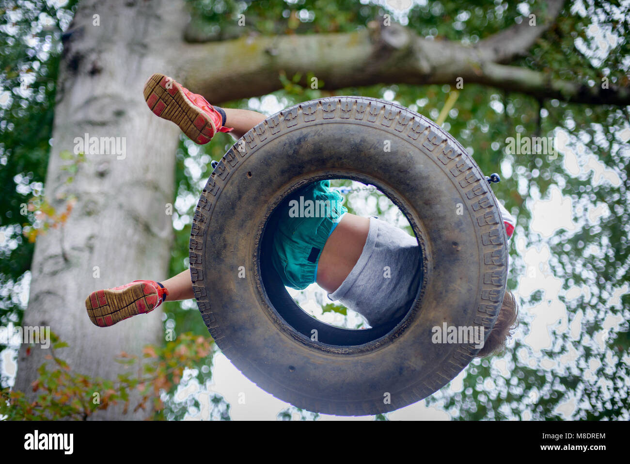Boy playing tyre tire hi-res stock photography and images - Alamy