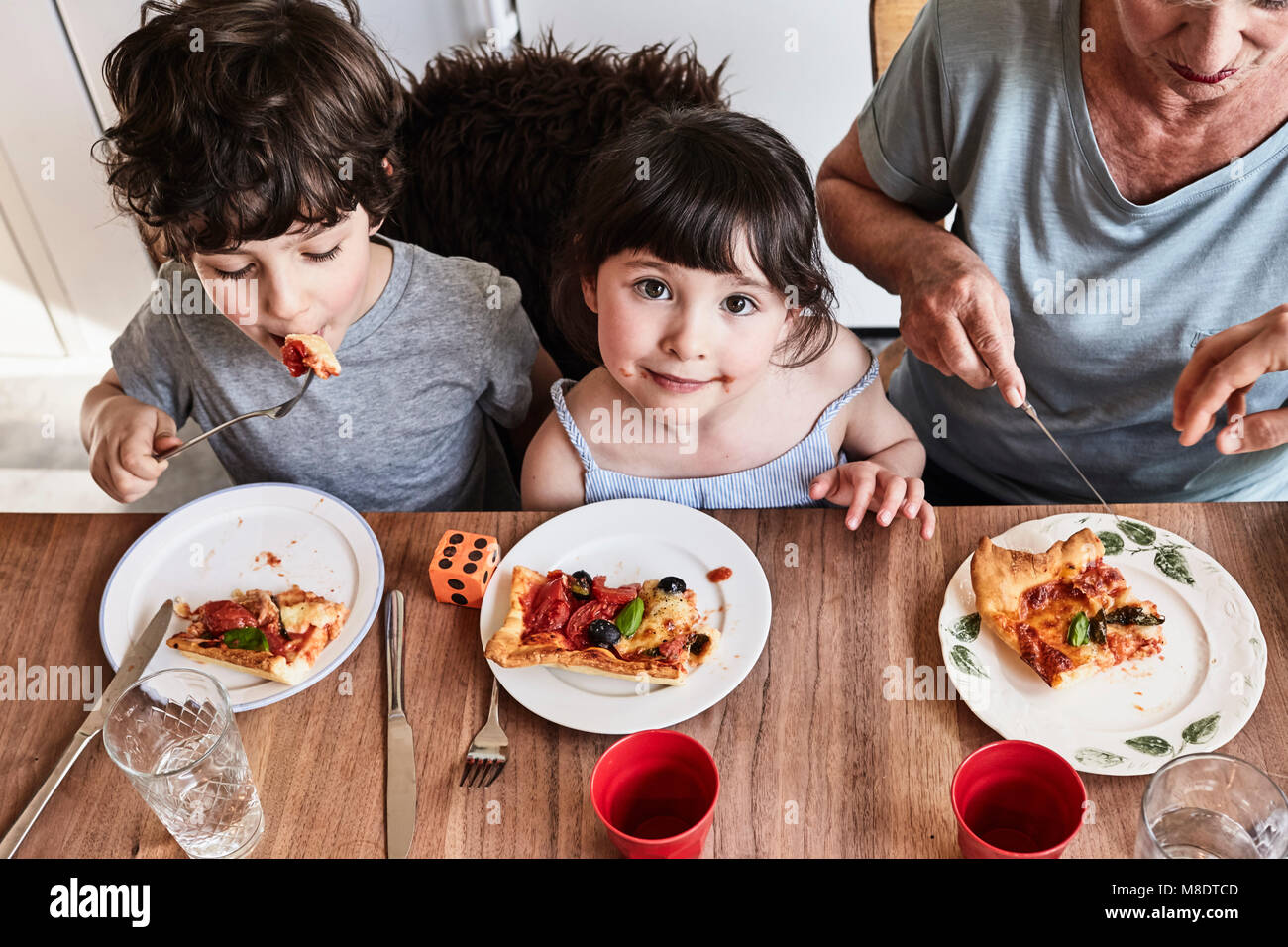 Child eating at table hi-res stock photography and images - Alamy