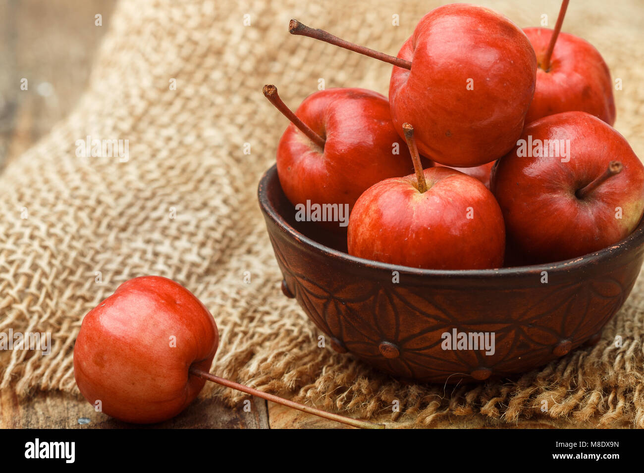 Small red apples. Ranetki. Rustic style. Selective focus Stock Photo ...