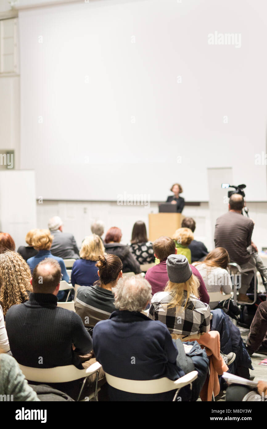 Woman giving presentation on business conference Stock Photo - Alamy