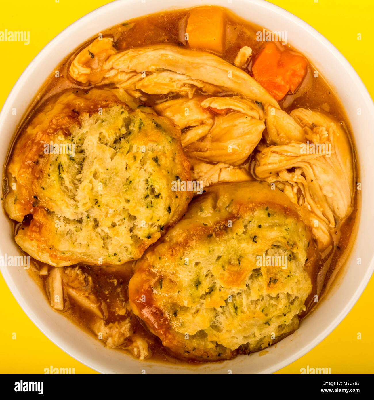 Traditional Chicken And Dumpling Casserole Against A Yellow Background ...