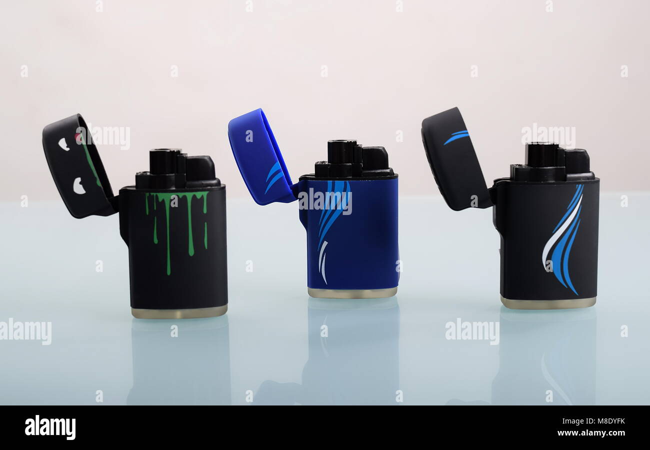 Three cigarette lighters Stock Photo - Alamy