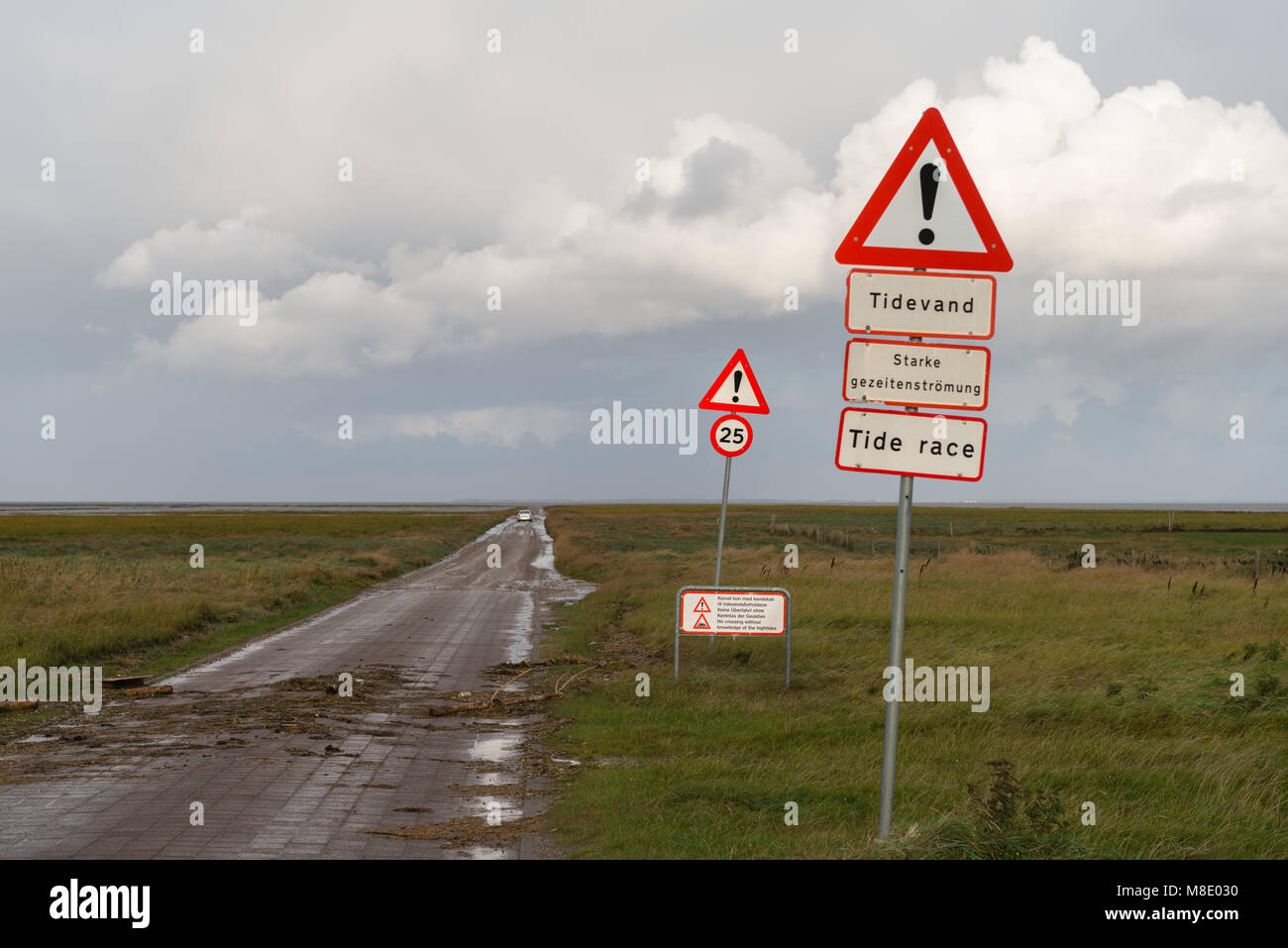 Road signs warning cars of the dangers of driving on the sea ground ...