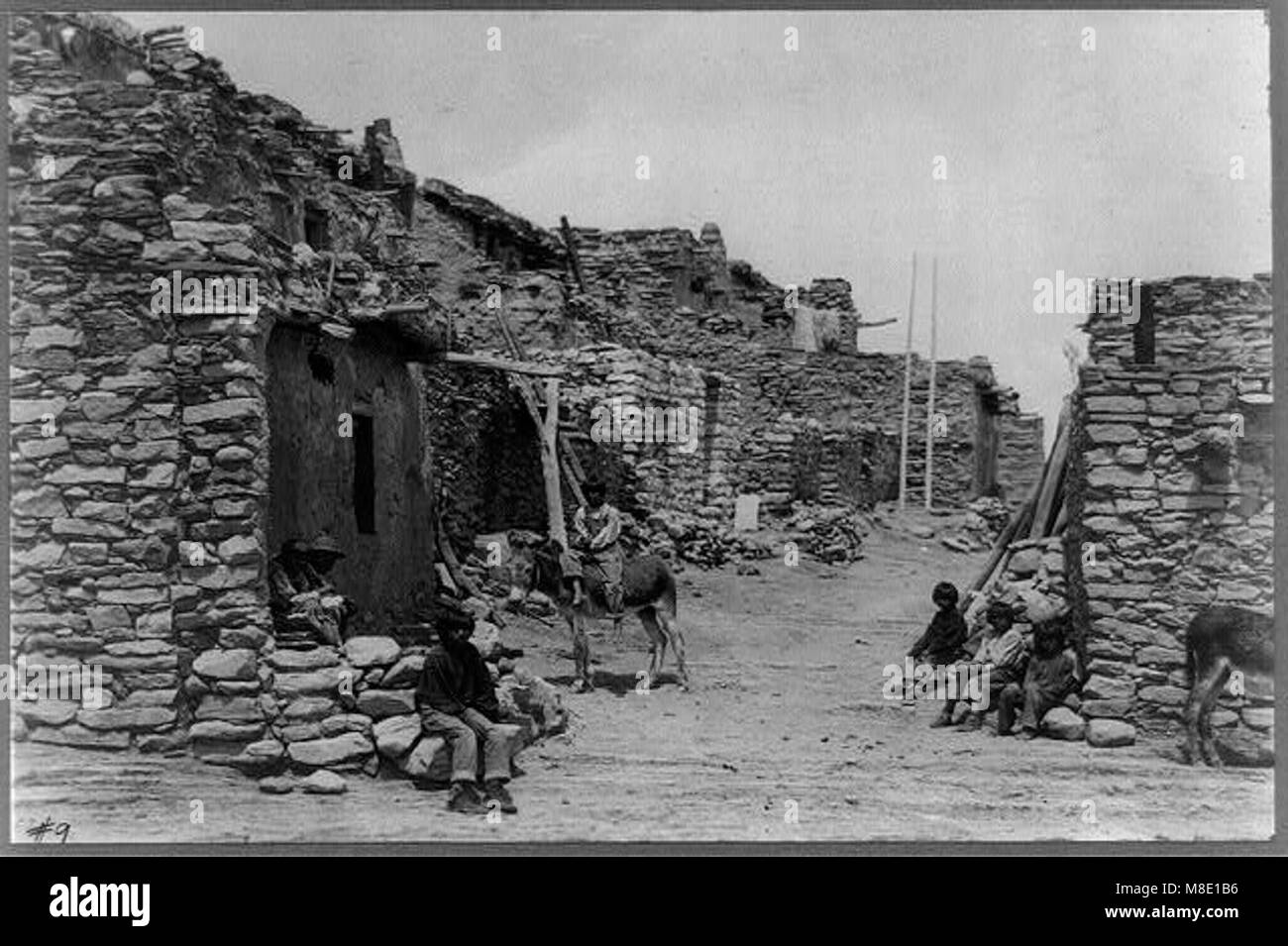 This photograph captures a street scene in Mishongnovi, a village ...